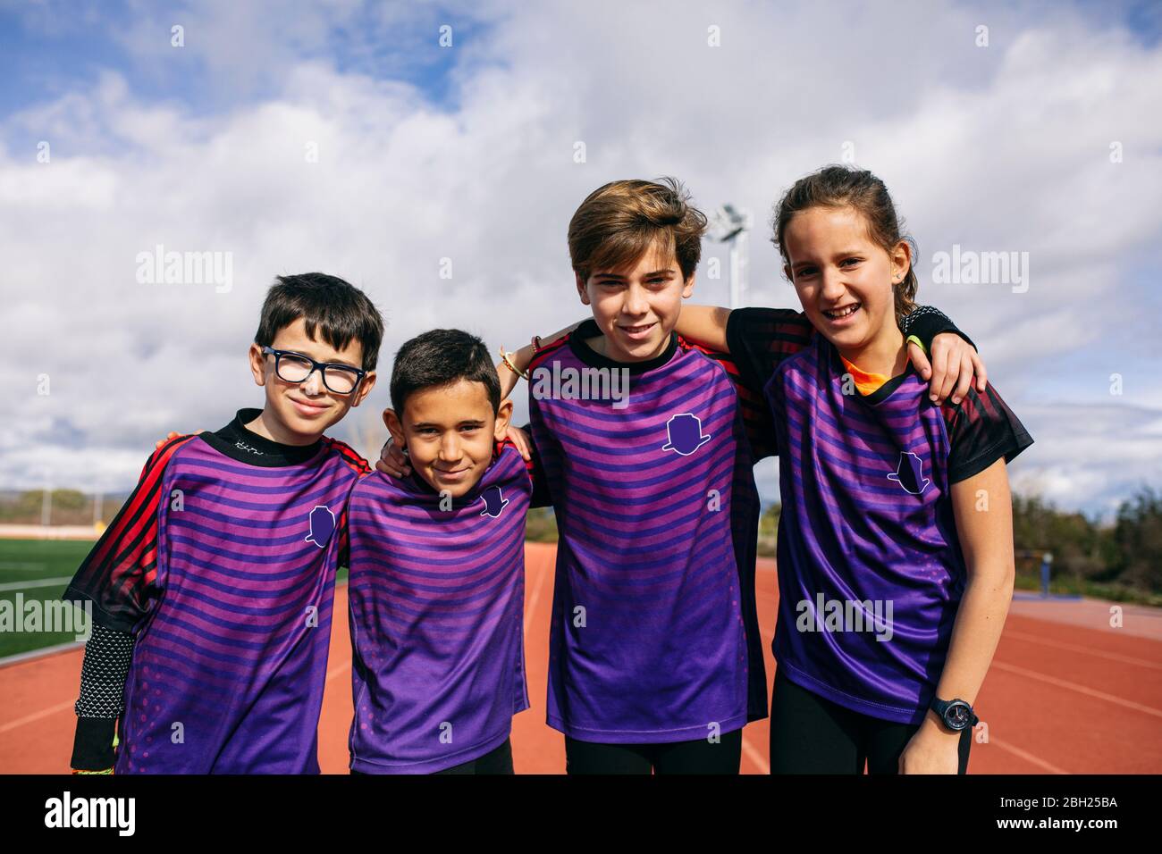 Friends sports team standing on running track hi-res stock photography ...