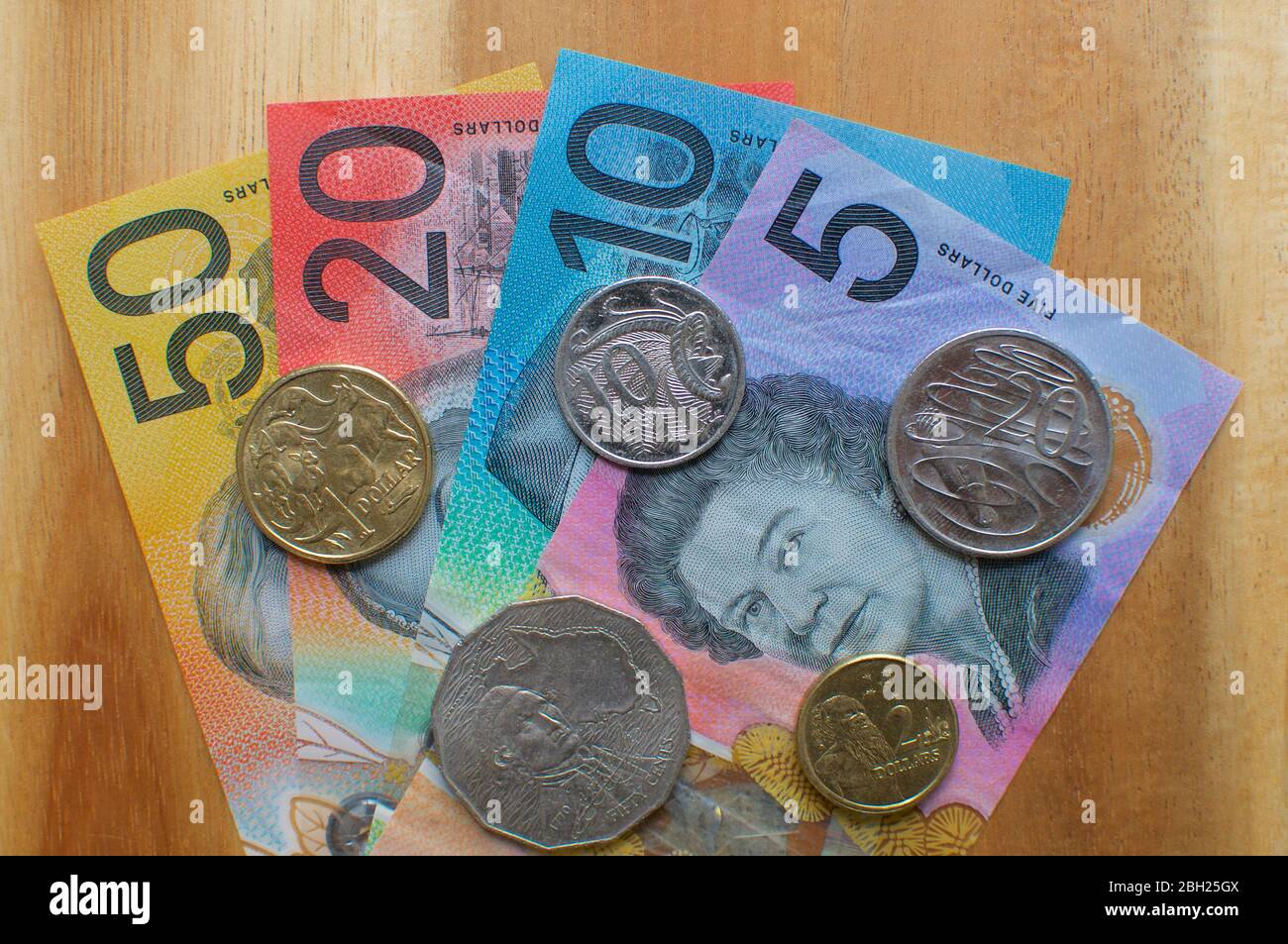 Close up picture of Australian banknotes and coins on a wooden table ... Close up picture of Australian banknotes and coins on a wooden table ...