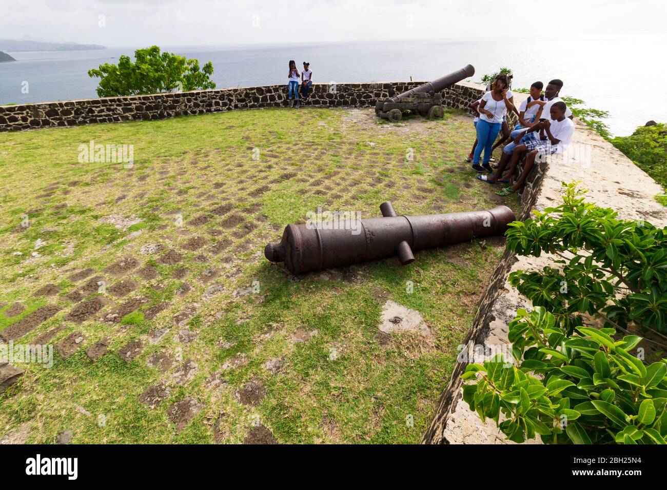 Rusted canons on the grassy top of Fort Rodney at Pigeon Island ...