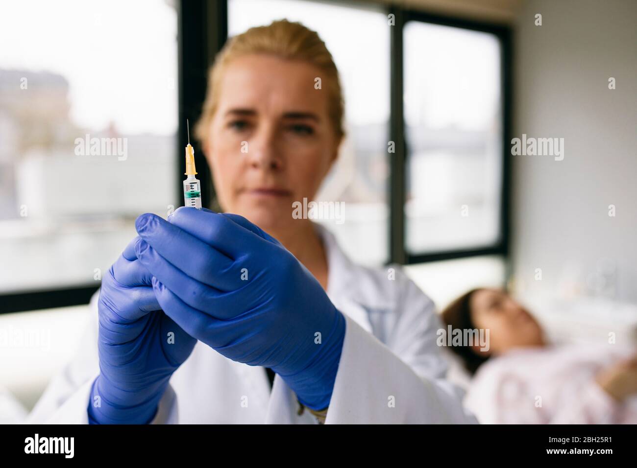 Female doctor preparing injection in hi-res stock photography and ...