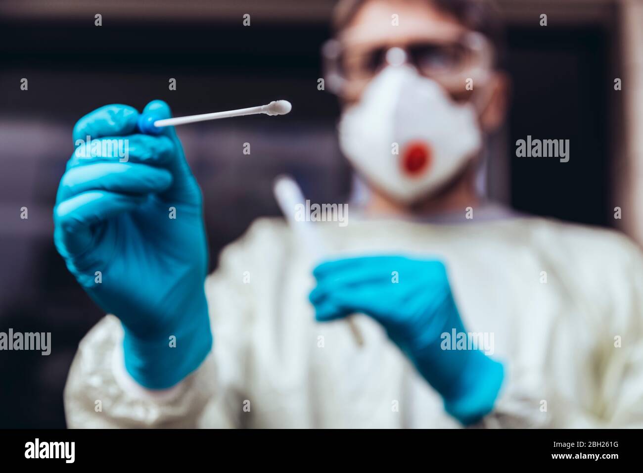 Healthcare worker holding swab test kit for PCR testing Stock Photo - Alamy