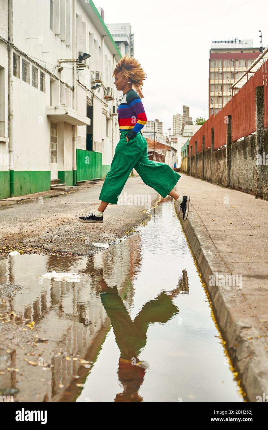 Jumping over puddle hi-res stock photography and images - Alamy