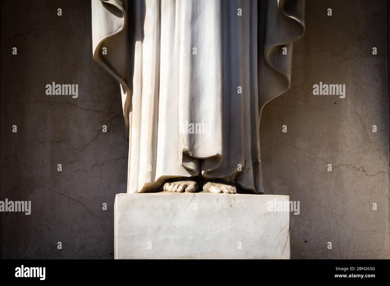 Bare feet of a statue poking out in humility Stock Photo - Alamy