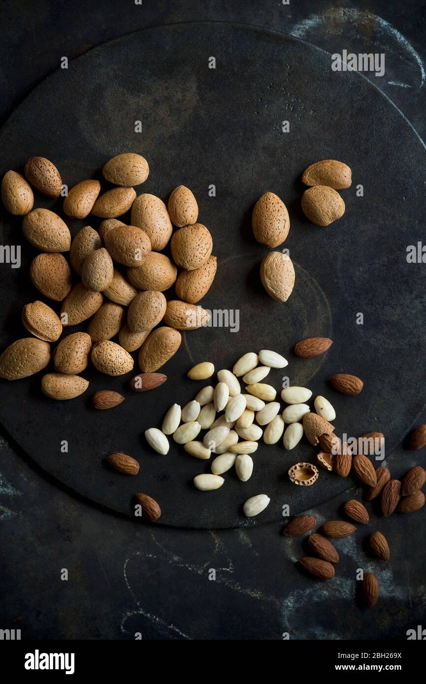 Almonds lying on rustic baking sheet Stock Photo - Alamy