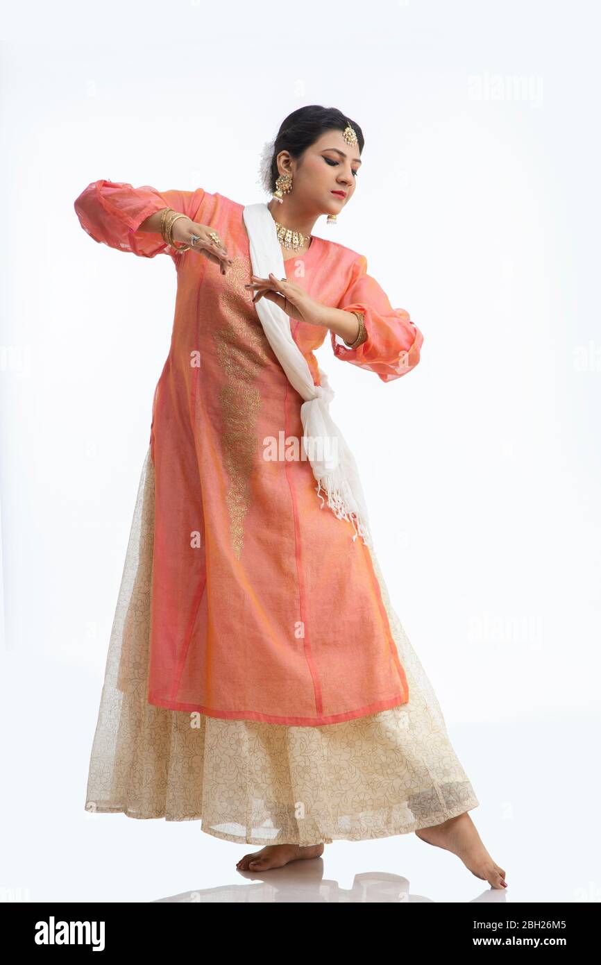Kathak dancer giving a mesmerising performance in front of a white ...