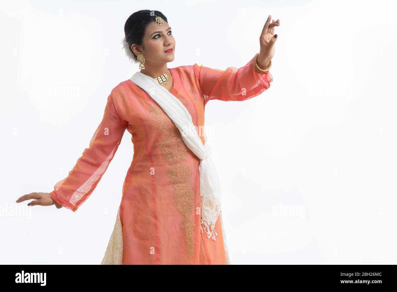 Beautiful kathak dancer performing in front of a white background Stock ...