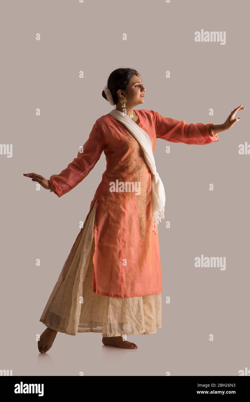 Beautiful kathak dancer performing over a plain background Stock Photo ...