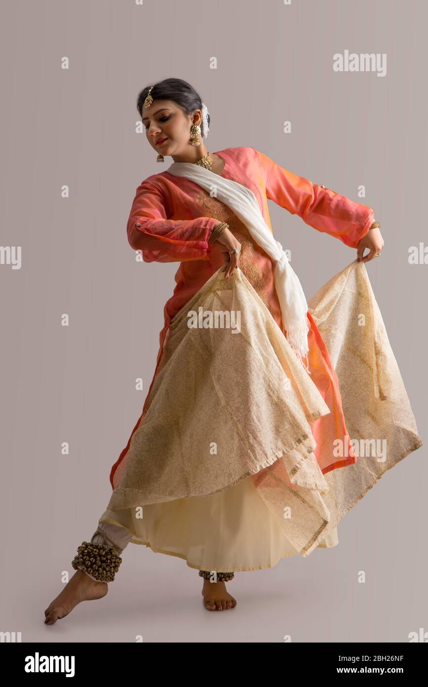Kathak dancer performing gracefully over a plain background Stock Photo ...