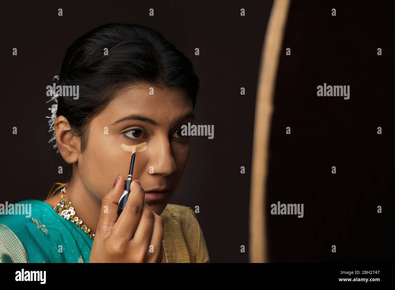 Kathak dancer applying makeup on her face Stock Photo - Alamy