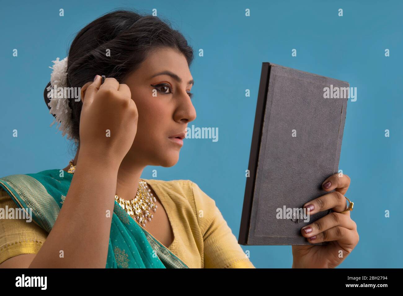 Kathak dancer looking at her makeup in the mirror Stock Photo - Alamy