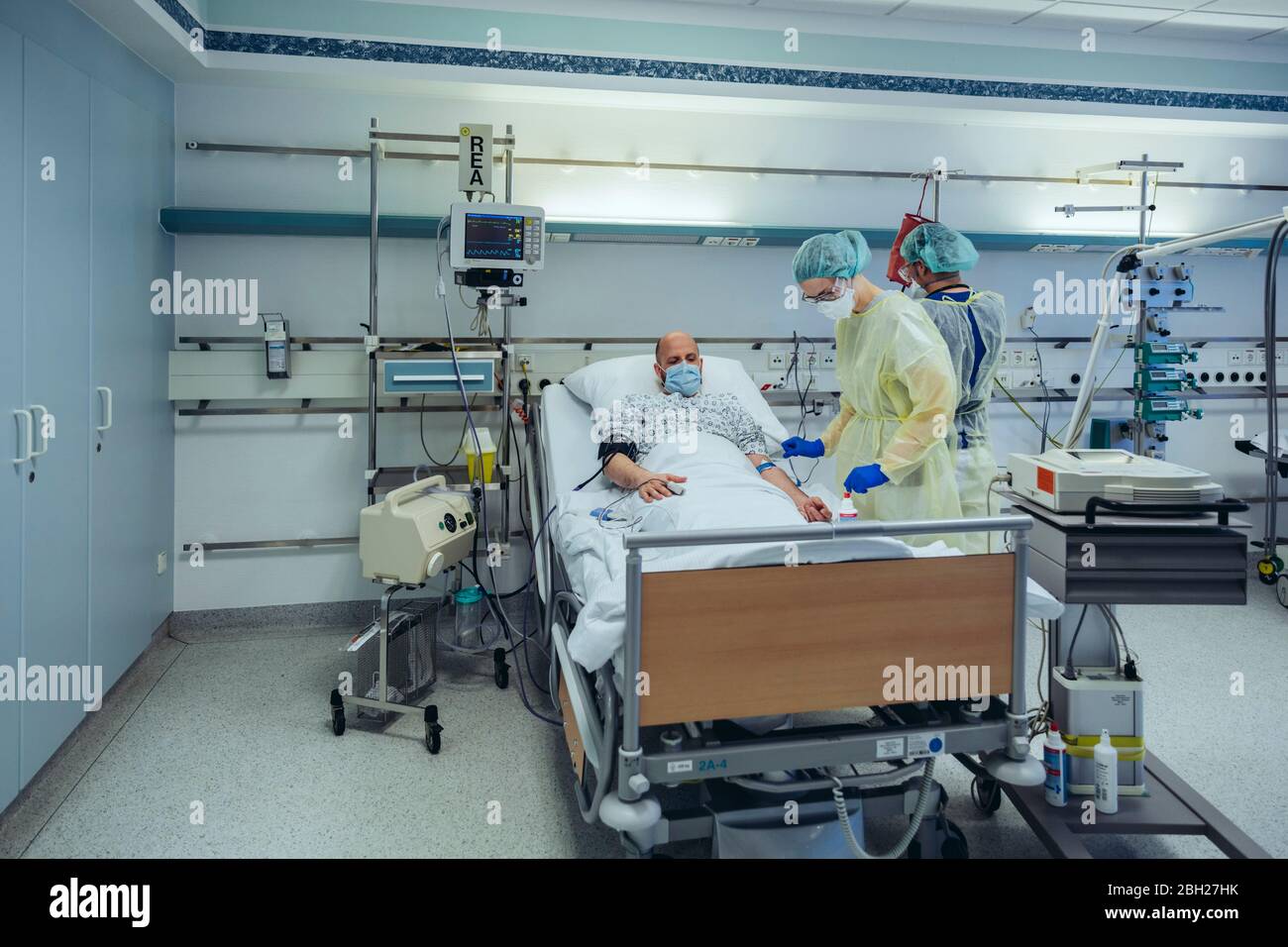 Doctors caring for patient in emergency care unit of a hospital taking ...