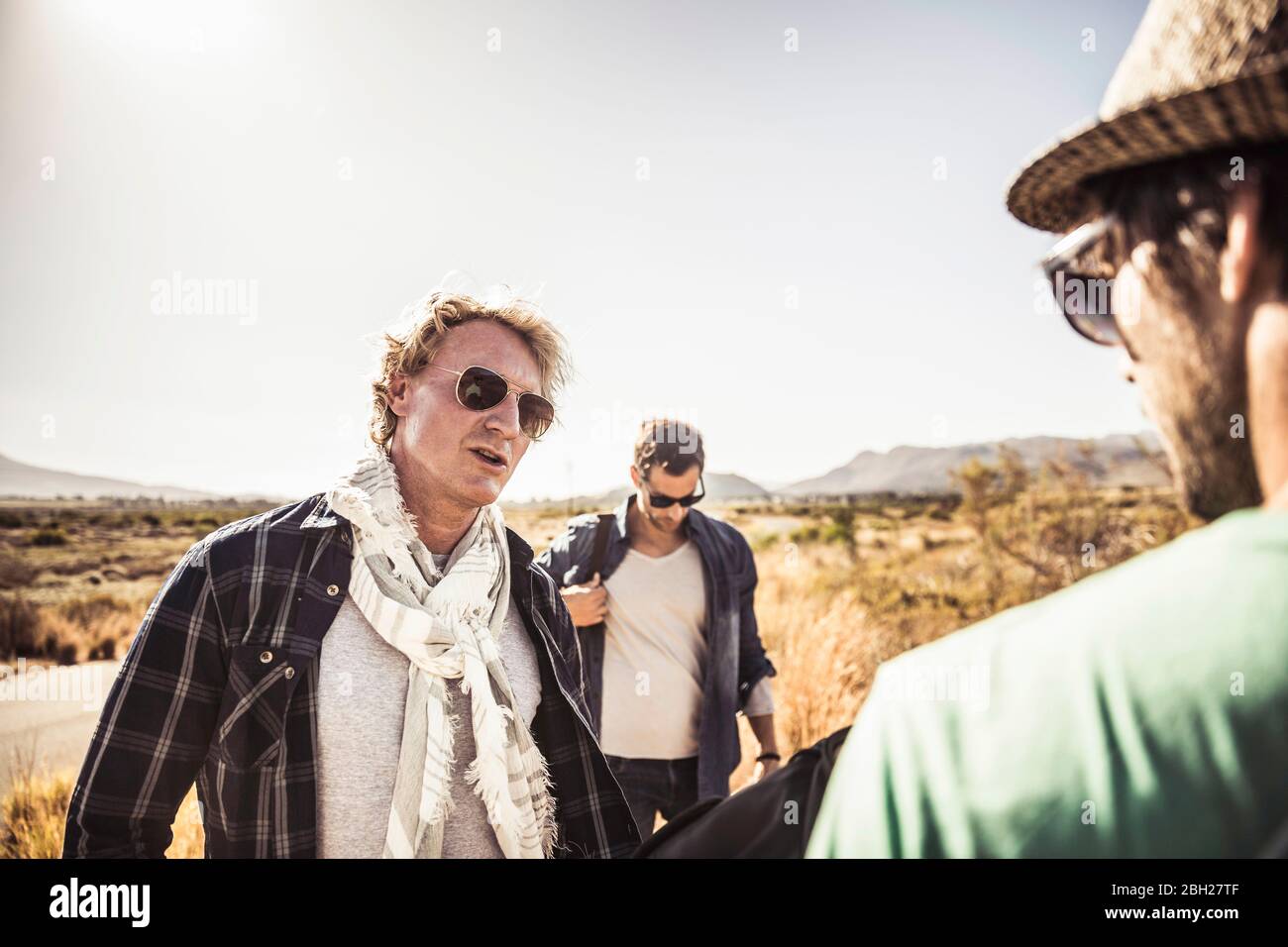 Three men talking in the countryside Stock Photo - Alamy