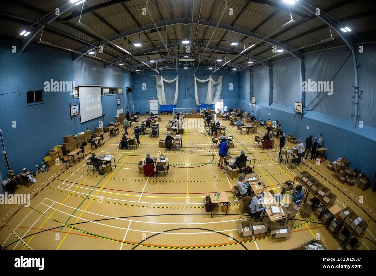 A volunteer PPE manufacturing initiative set up in a school sports hall ...