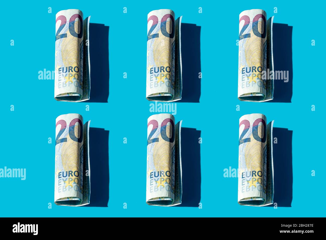 Twenty euro rolled banknotes pattern on a blue background Stock Photo ...