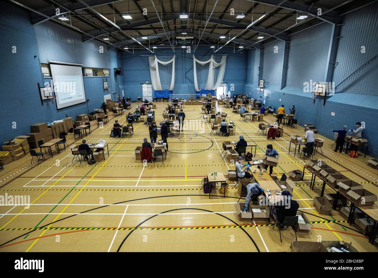 A volunteer PPE manufacturing initiative set up in a school sports hall ...