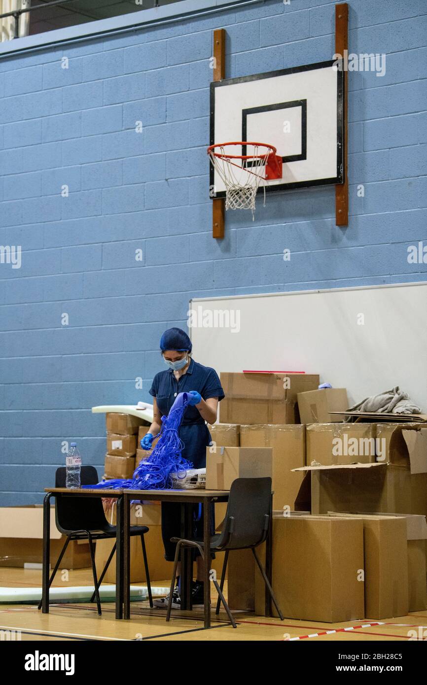 A volunteer PPE manufacturing initiative set up in a school sports hall ...