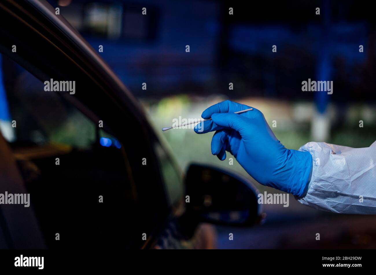 Doctor wearing protective clothing, doing viral swab test Stock Photo ...
