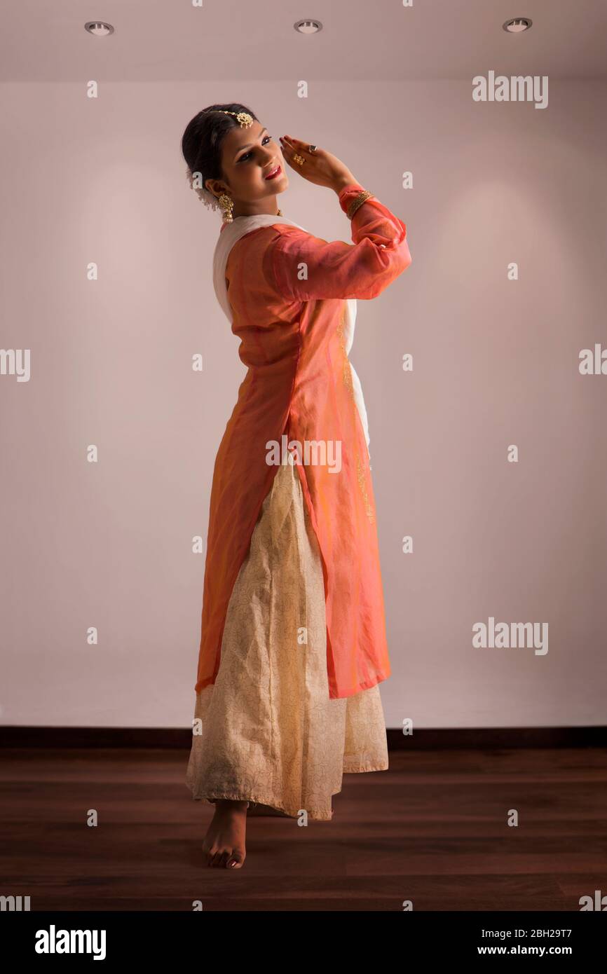 Beautiful kathak dancer performing through her expressions at home ...
