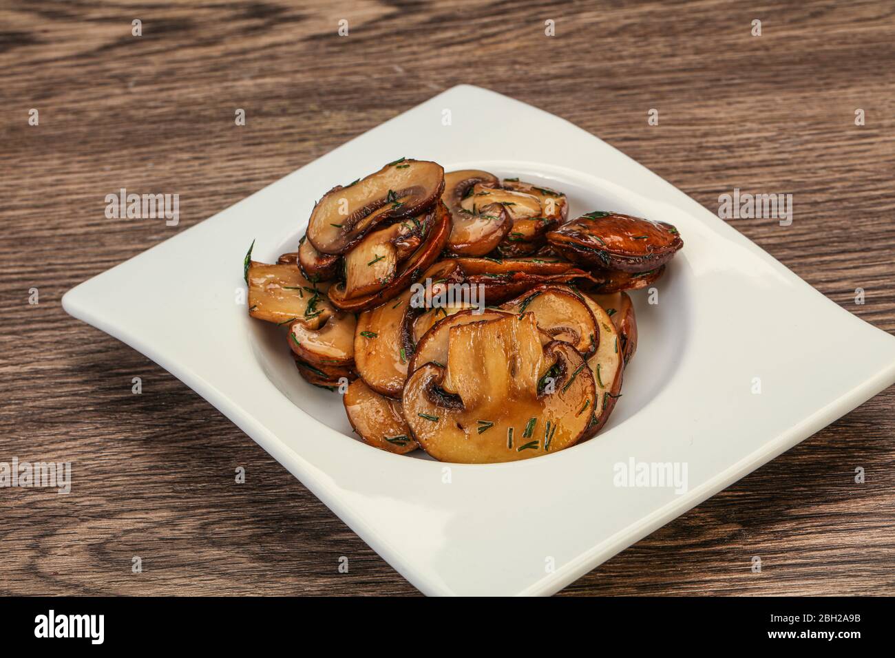 Roasted champignon with herbs and spices in the bowl Stock Photo - Alamy