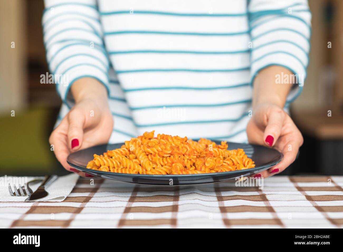 Woman holding pasta table hi-res stock photography and images - Alamy