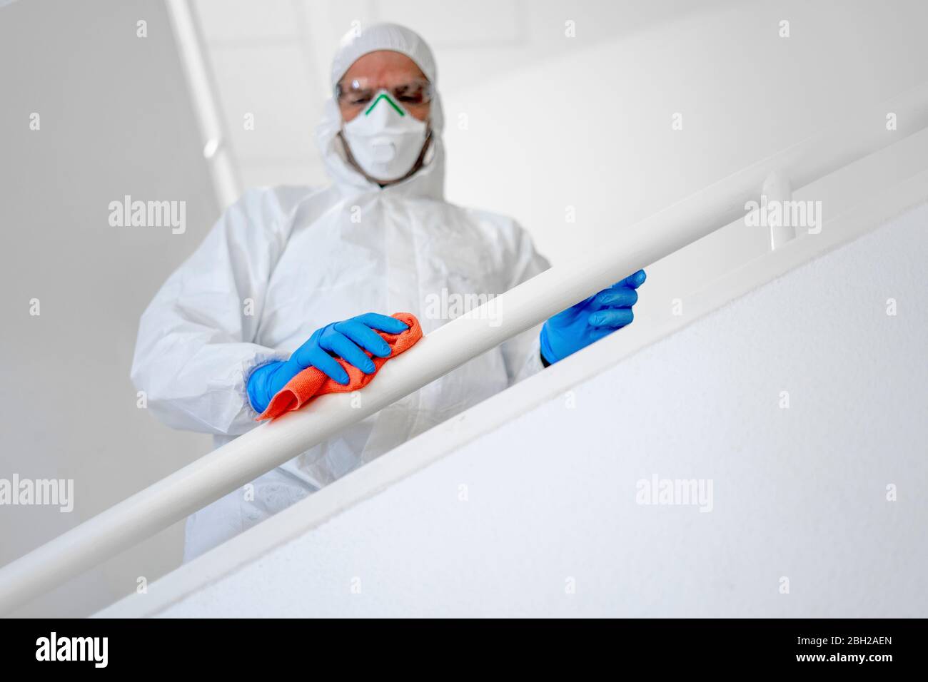 Cleaning staff desinfecting hospital against contageous virus, wearing ...