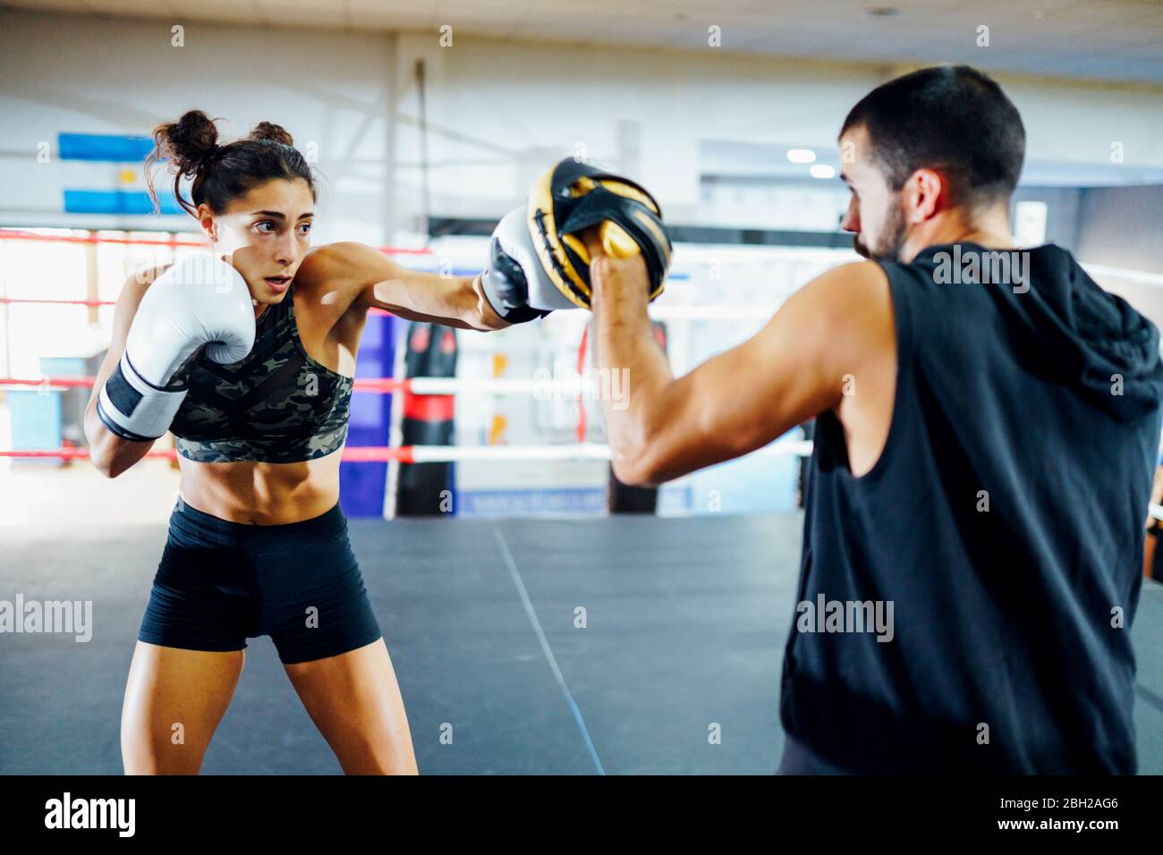 Female boxer sparring with her coach in gym Stock Photo - Alamy