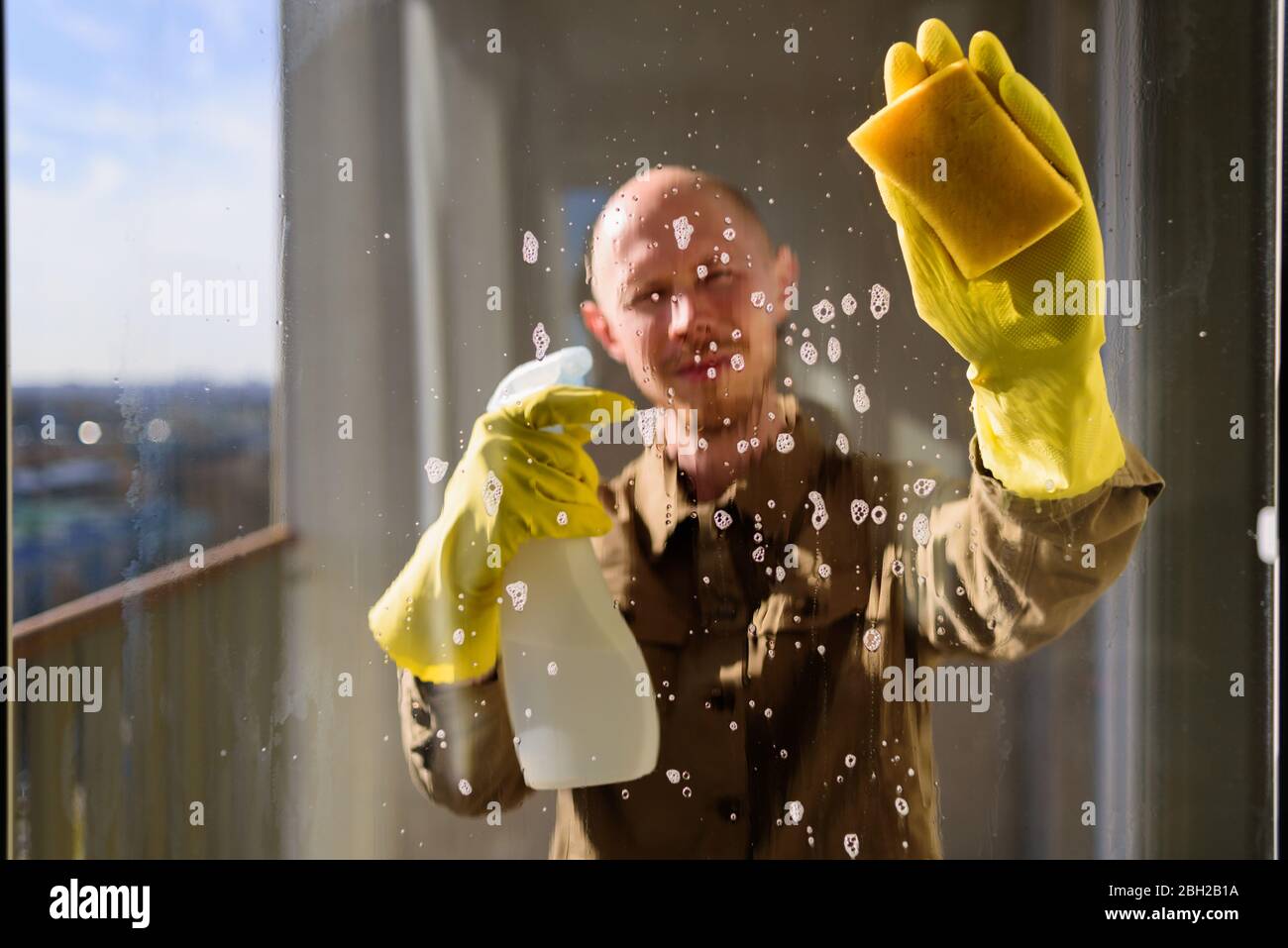 Male washer in gloves hi-res stock photography and images - Alamy