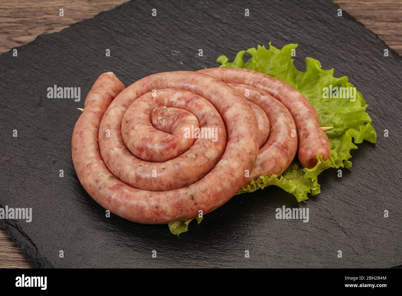 Raw pork sausage ring for grill Stock Photo - Alamy