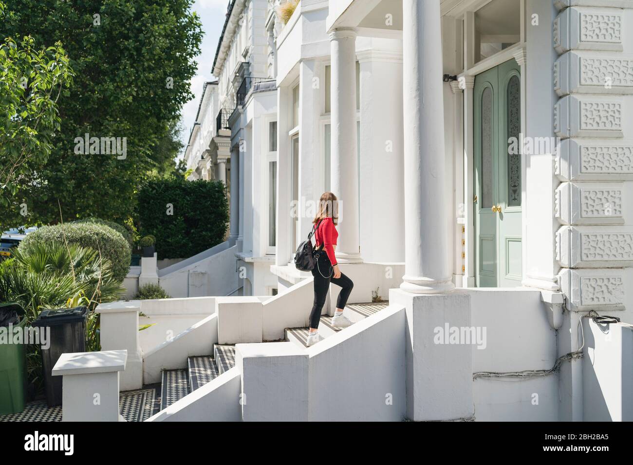 Woman walking stairs house hi-res stock photography and images - Alamy