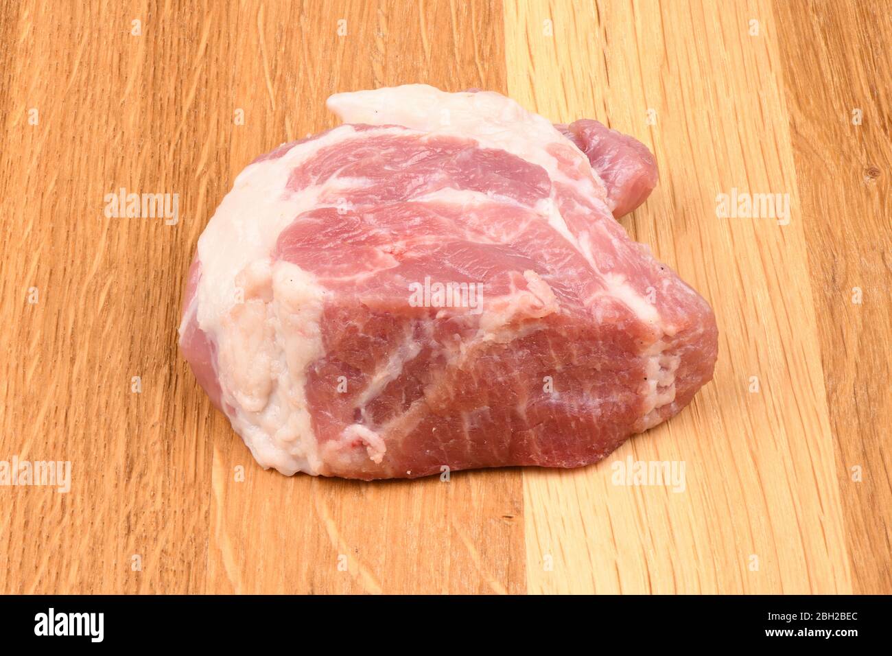 Fresh raw pork steak isolated on wood background. High resolution photo ...