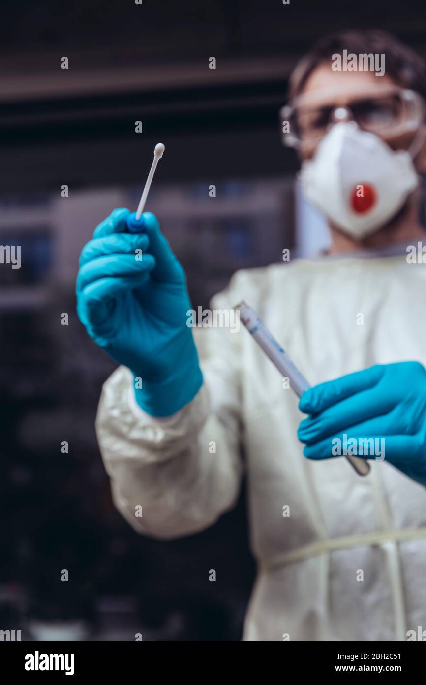 Healthcare worker holding swab test kit for PCR testing Stock Photo - Alamy