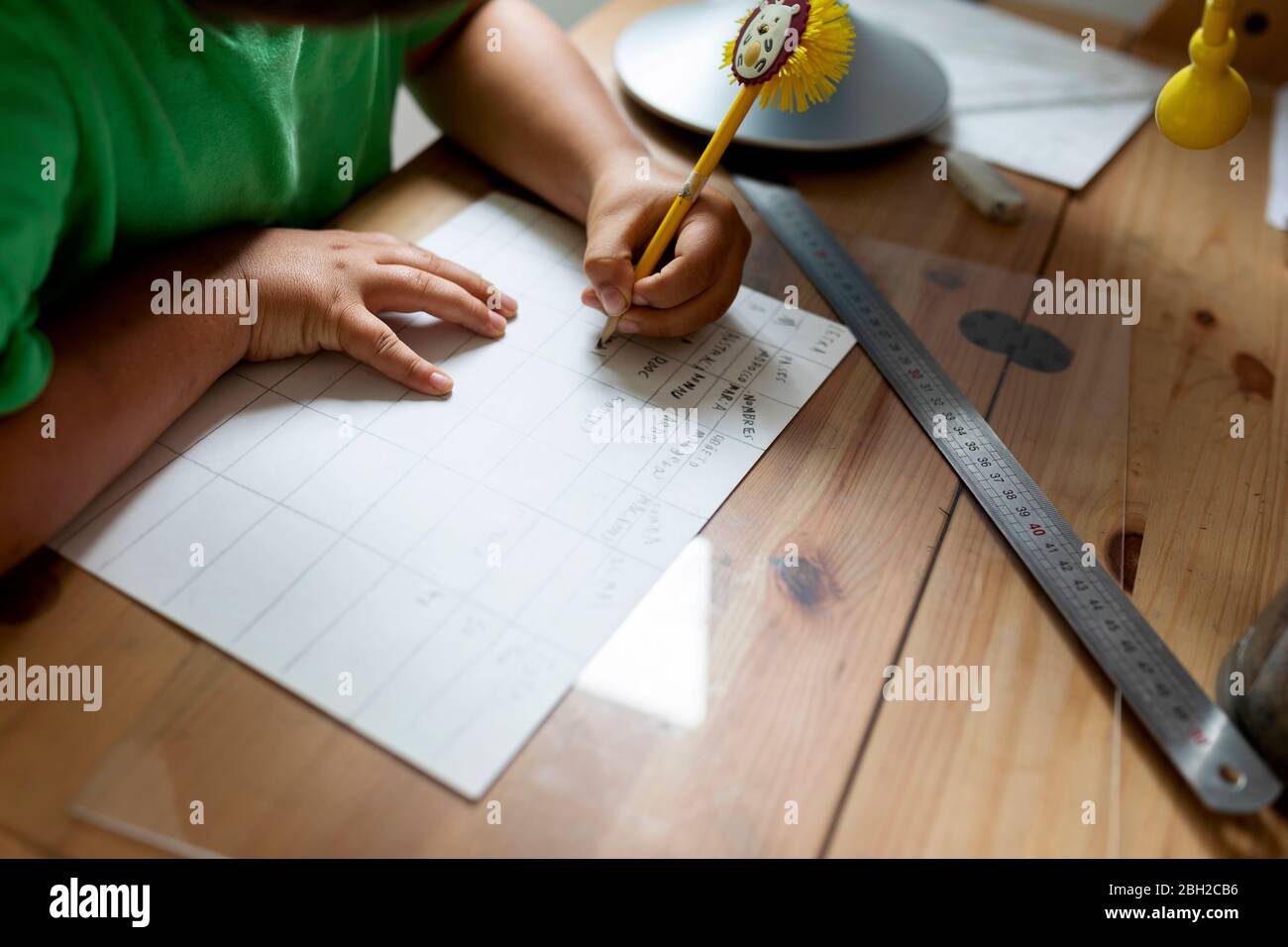 Boy doing homework sitting hi-res stock photography and images - Alamy