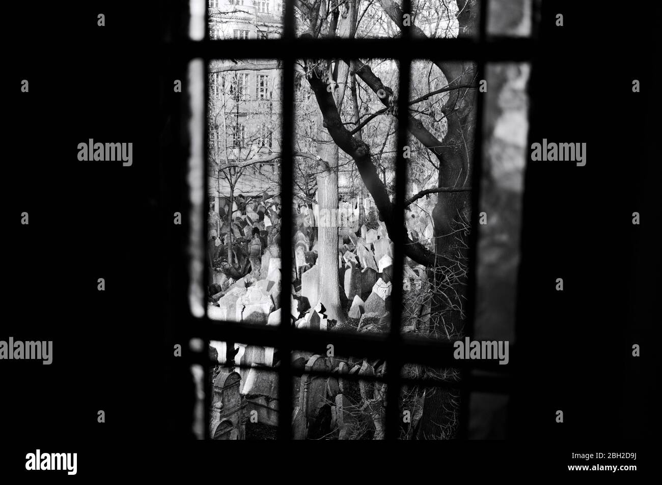 View of the headstones in the old Jewish cemetery through a window ...