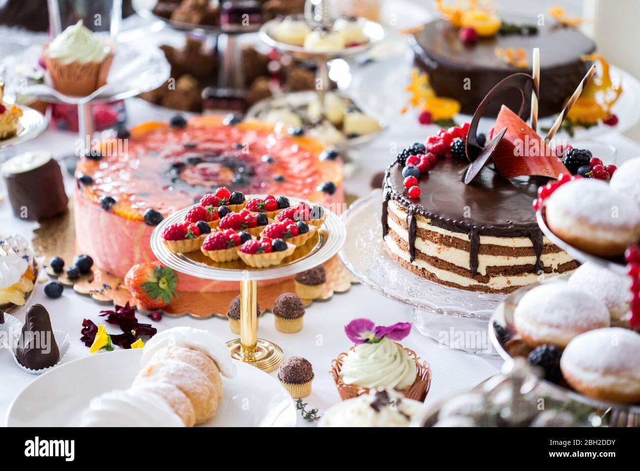 Dining table filled with all kinds of snacks and desserts Stock Photo ...