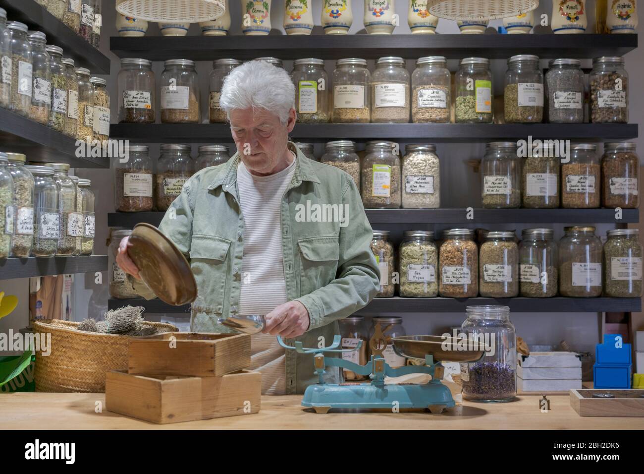 Man working behind counter in hi-res stock photography and images - Alamy