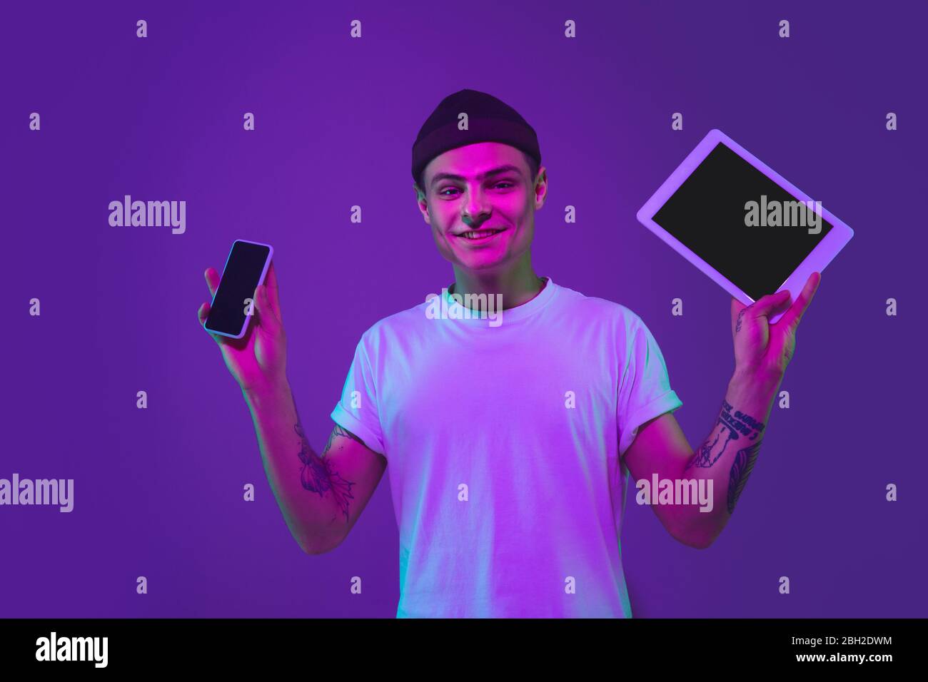 Device's blank screen. Caucasian man's portrait isolated on purple ...