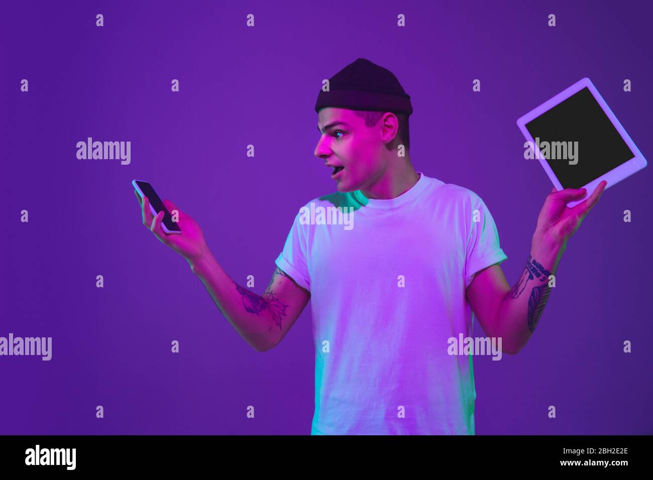 Device's blank screen. Caucasian man's portrait isolated on purple ...