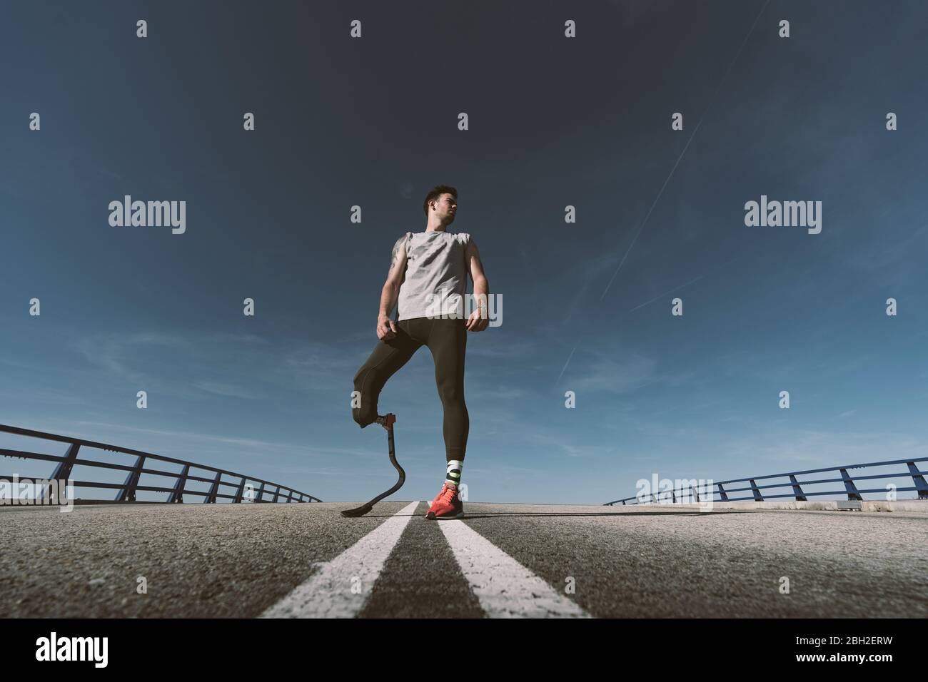 Disabled athlete with leg prosthesis standing on a road Stock Photo - Alamy