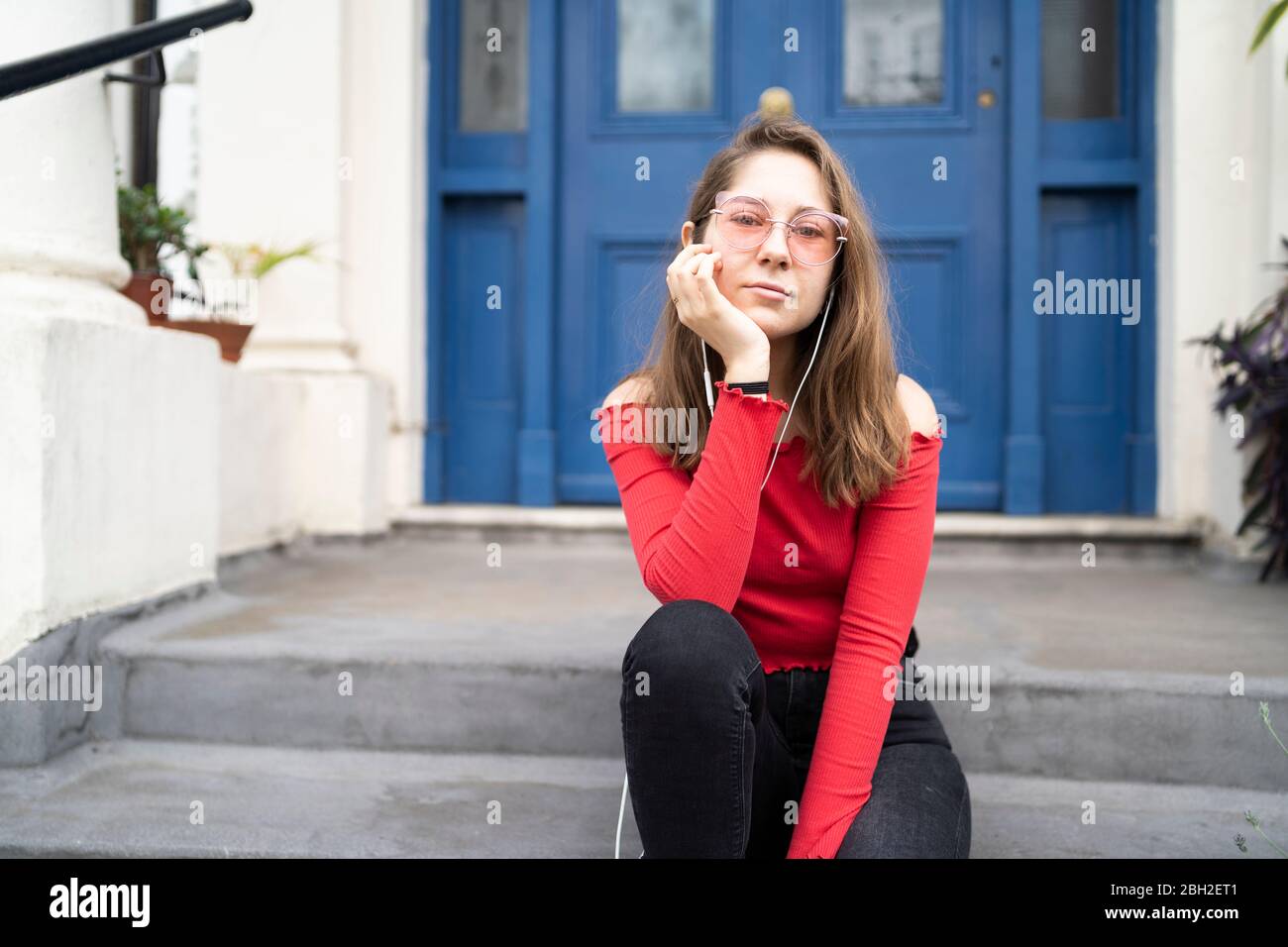 Young woman sitting on stoop High Resolution Stock Photography and ...
