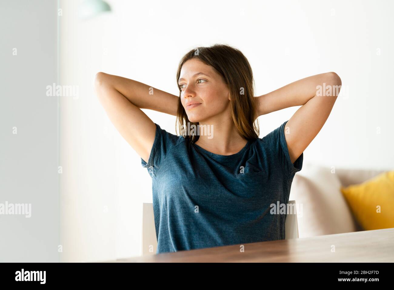 Woman sitting sideways on couch hi-res stock photography and images - Alamy