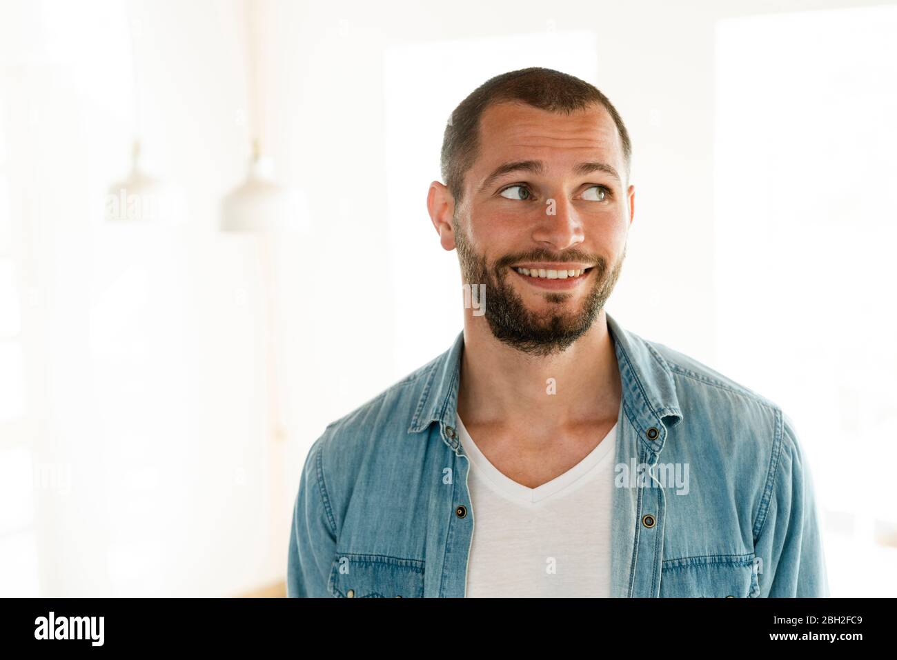 Portrait of funny young man looking sideways Stock Photo - Alamy
