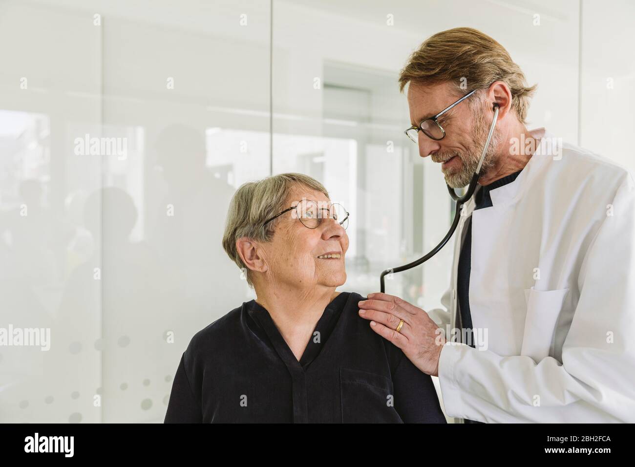 Doctor examining senior patient in medical practice Stock Photo - Alamy