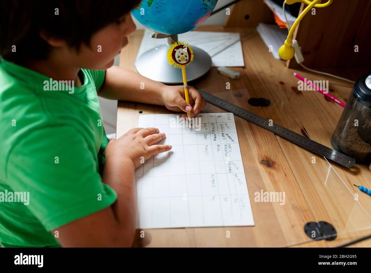 Boy sitting desk homework hi-res stock photography and images - Alamy