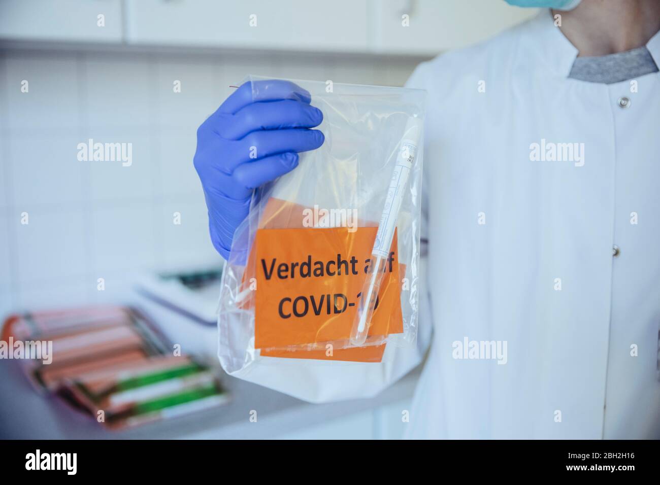 Hand holding Covid-19 swab in a plastic bag Stock Photo - Alamy