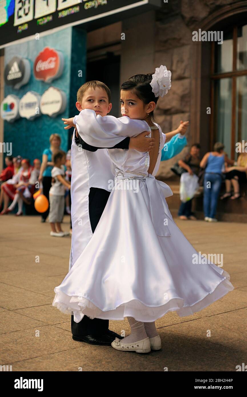 Little boy and girl in classical ball suits dancing on the street Stock ...