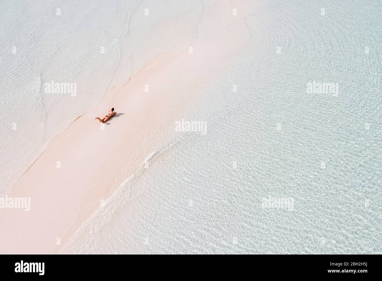 Woman sunbathing in the caribbean on the beach hi-res stock photography ...