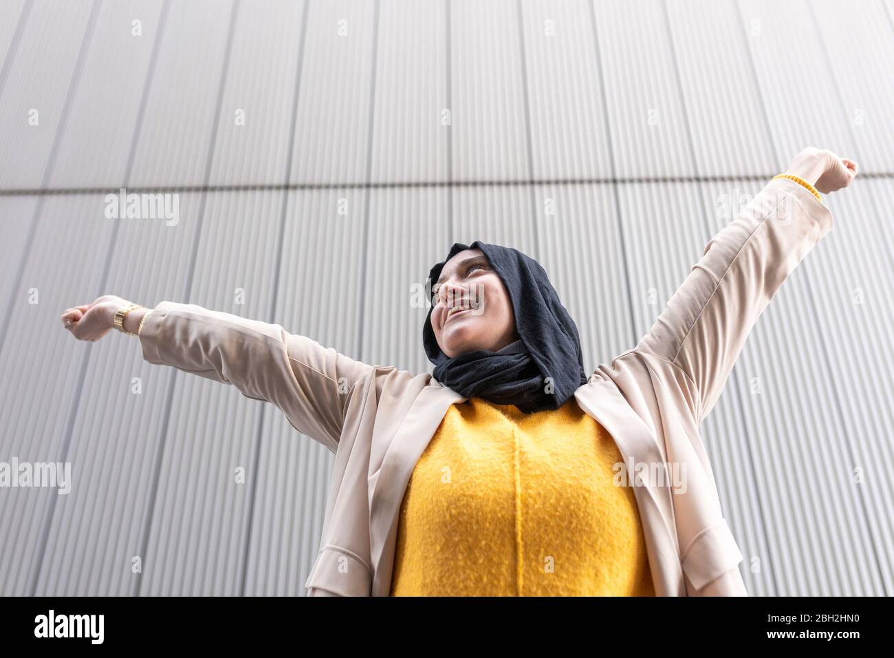 Excited woman with hands raised hi-res stock photography and images - Alamy