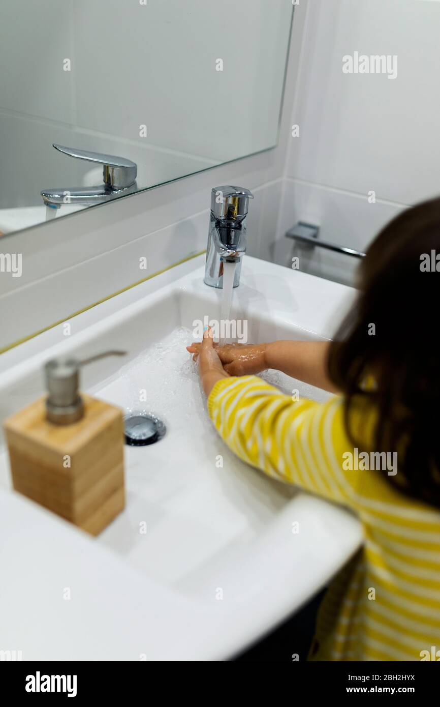 Little girl washing her hands Stock Photo - Alamy