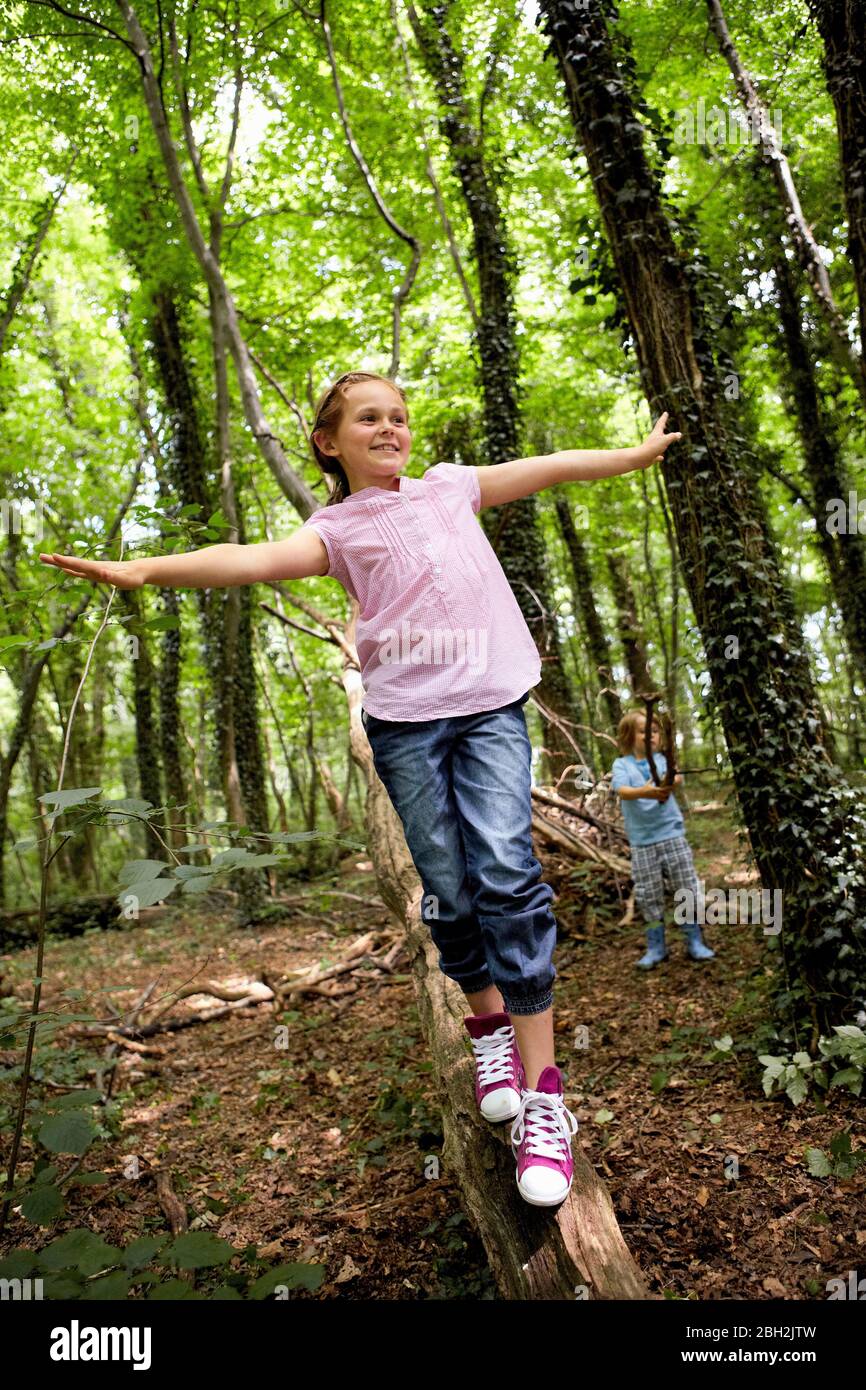 Girl on log hi-res stock photography and images - Alamy