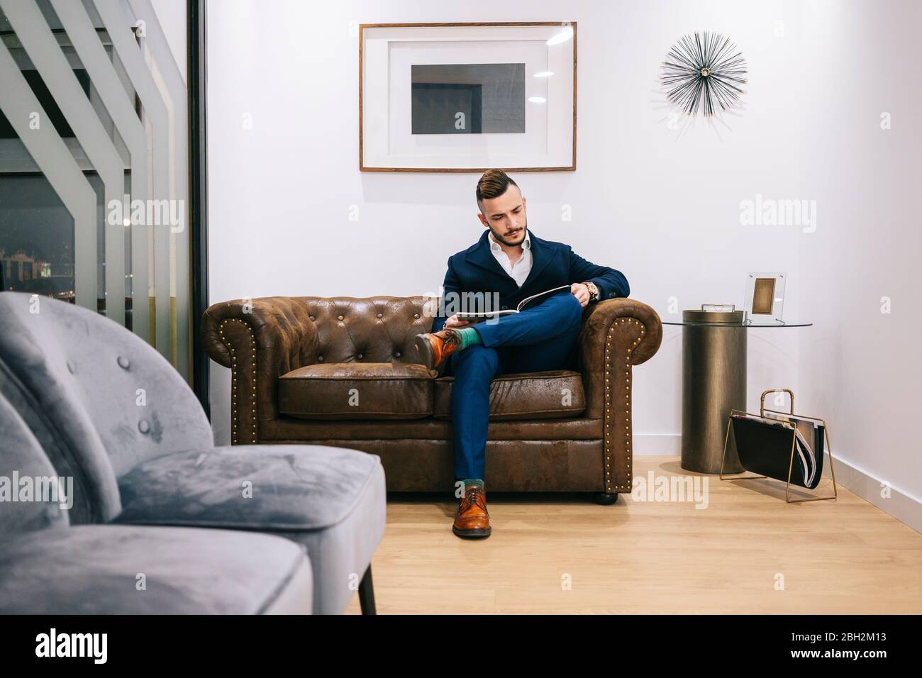 Patient in waiting room of a medical practice reading a magazine Stock ...